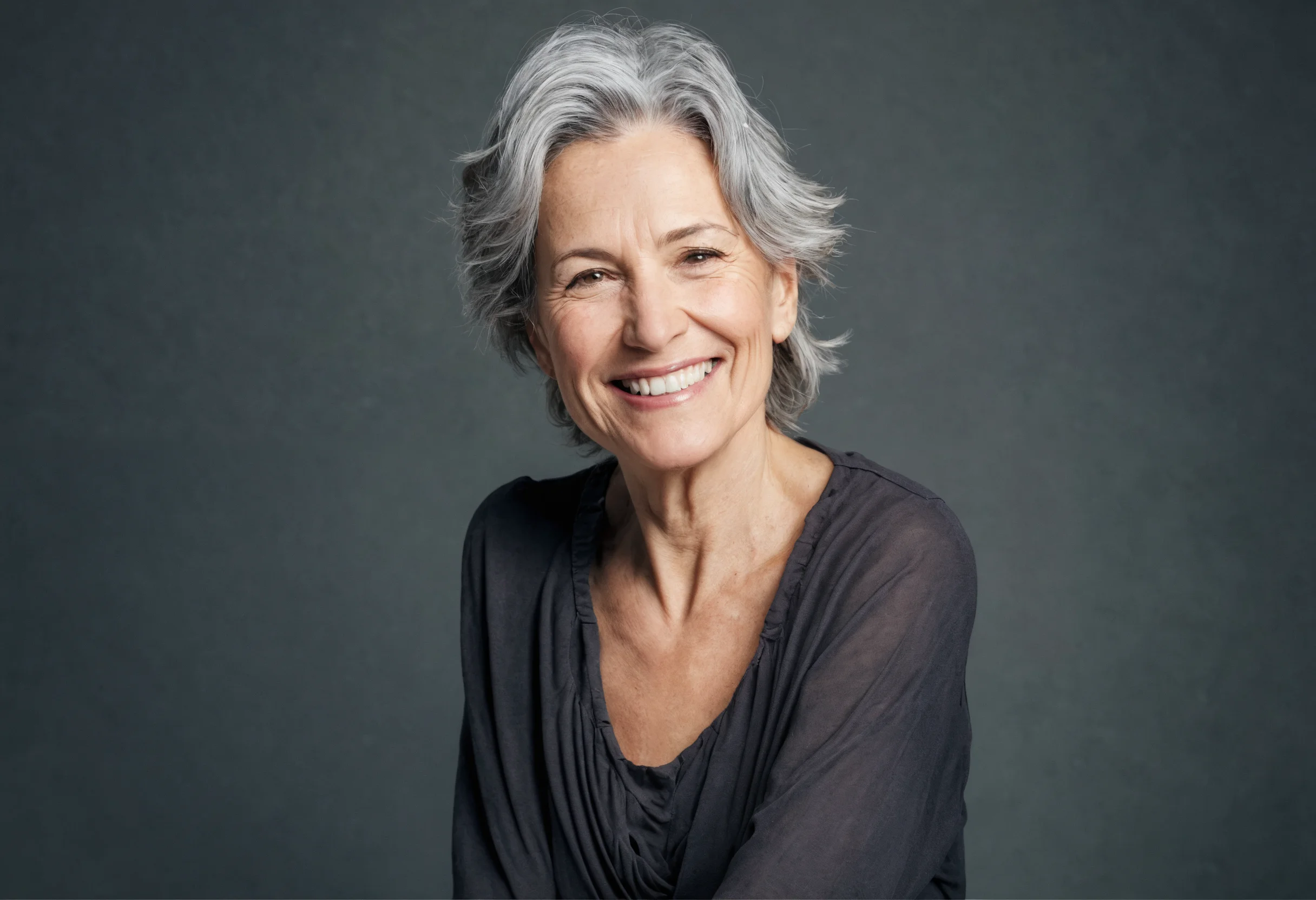 Lexica - Natural photo of a happy 52 year old woman on grey background ...