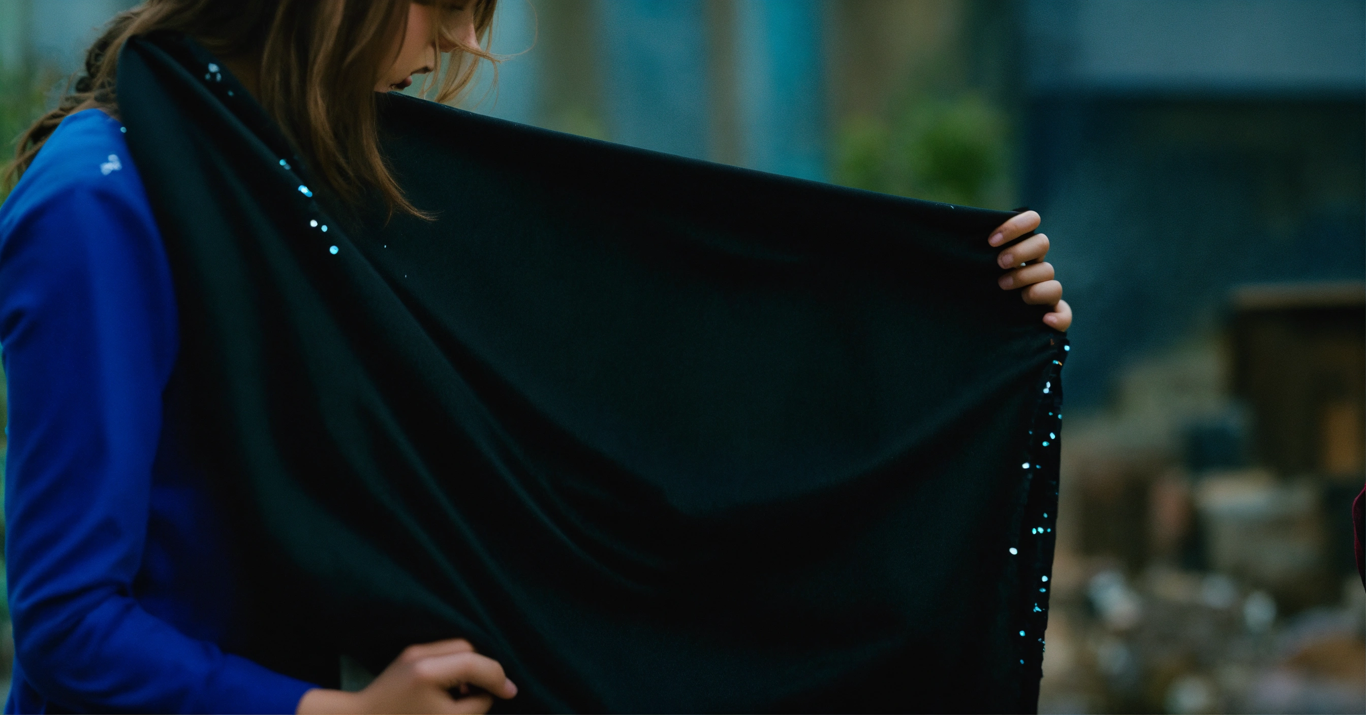 Lexica - A girl take off a black cloth covering a device